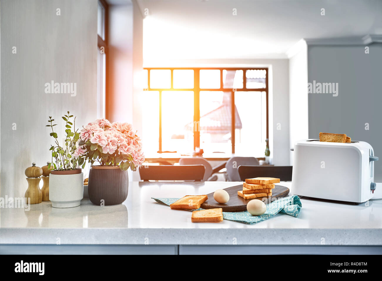 Hot morning in a white kitchen with fresh toast. Sun flare Stock Photo ...