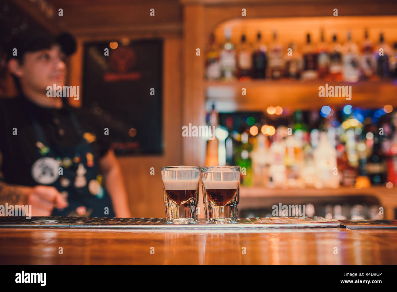 Bartender making shots on black bar with reflection Stock Photo - Alamy