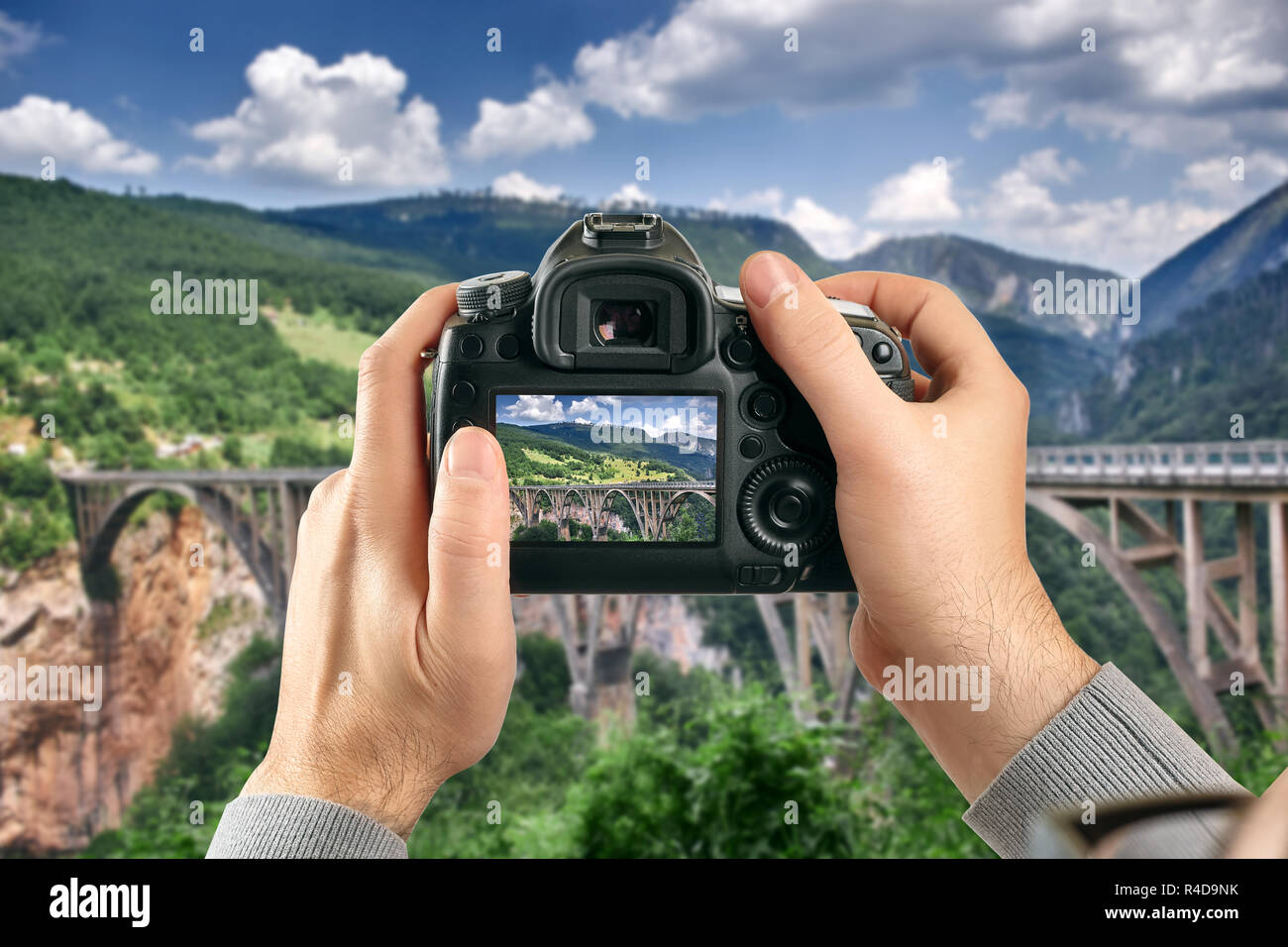 Digital single-lens reflex camera in hands. Man photographer makes ...