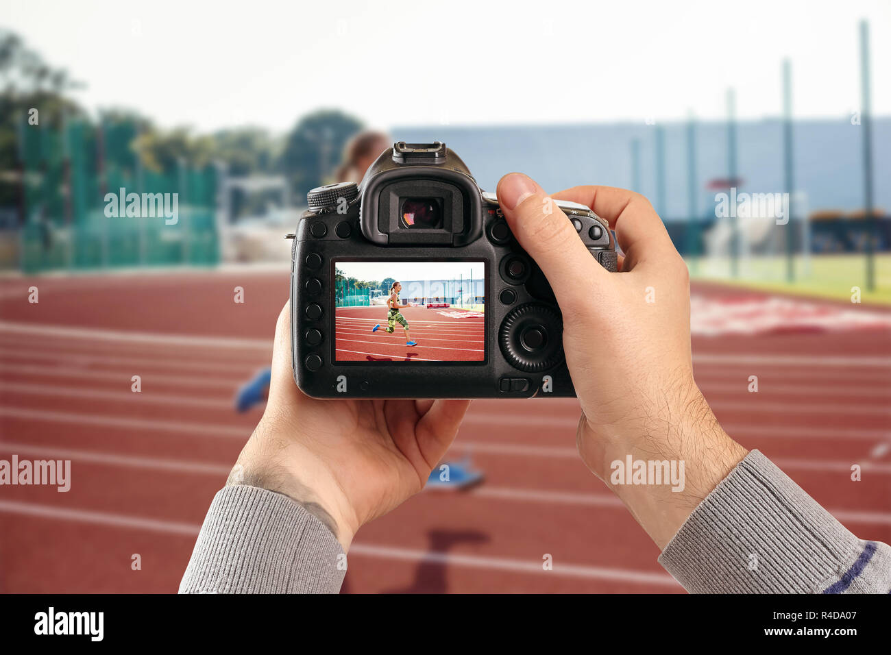 Digital single-lens reflex camera in hands. Man photographer makes ...