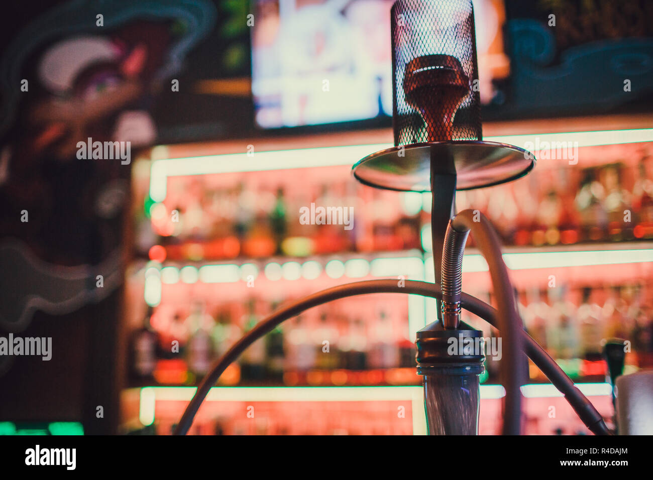 Hookah on a dark background of a blurry bar with a bokeh.Copy space ...