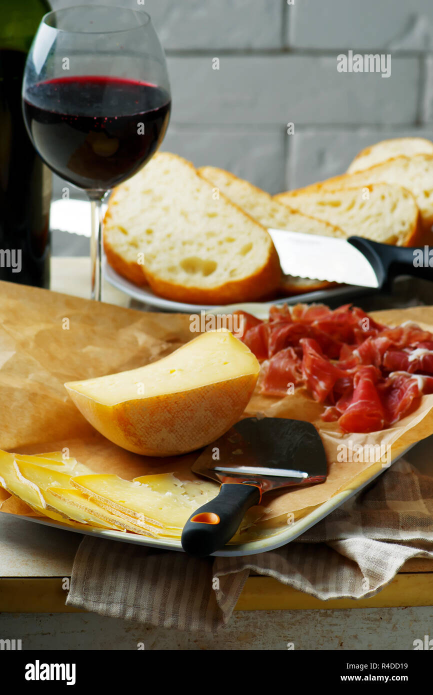 cheese, prosciutto, bread and red wine.style rustic.selective focus ...