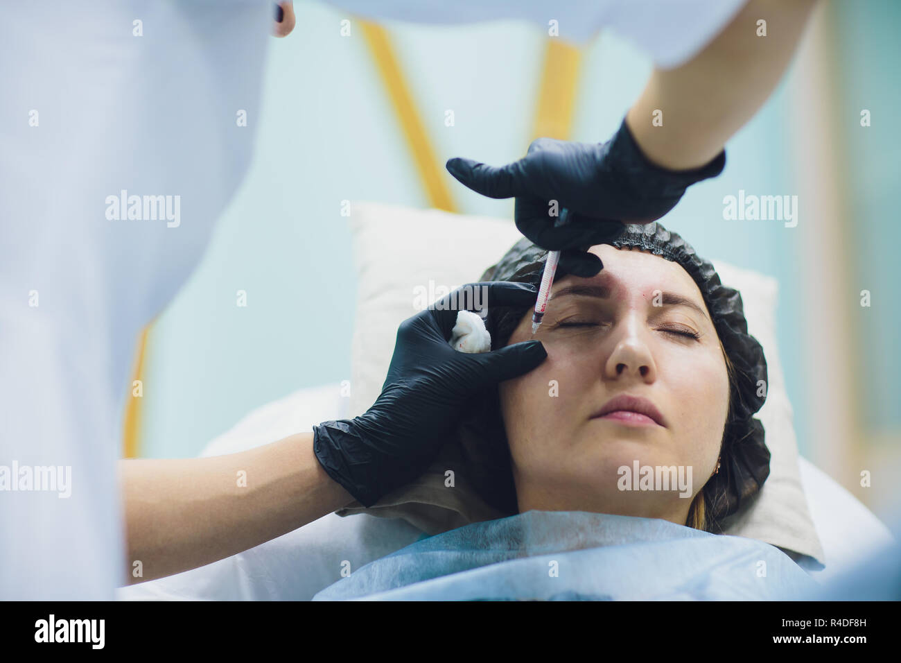 Cosmetologist doctor make facial beauty injections to her woman client ...