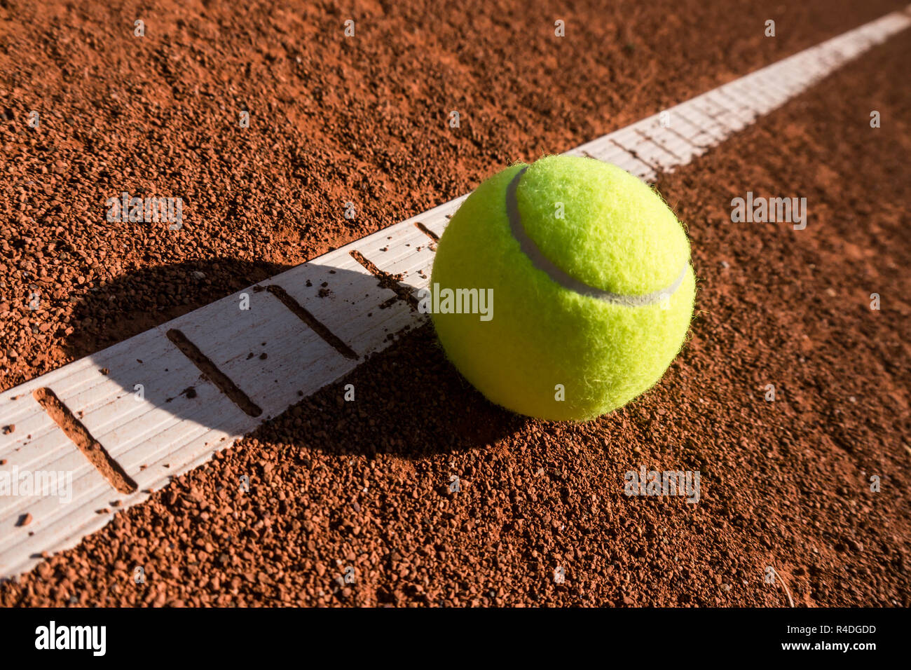 tennis ball next to the line Stock Photo - Alamy