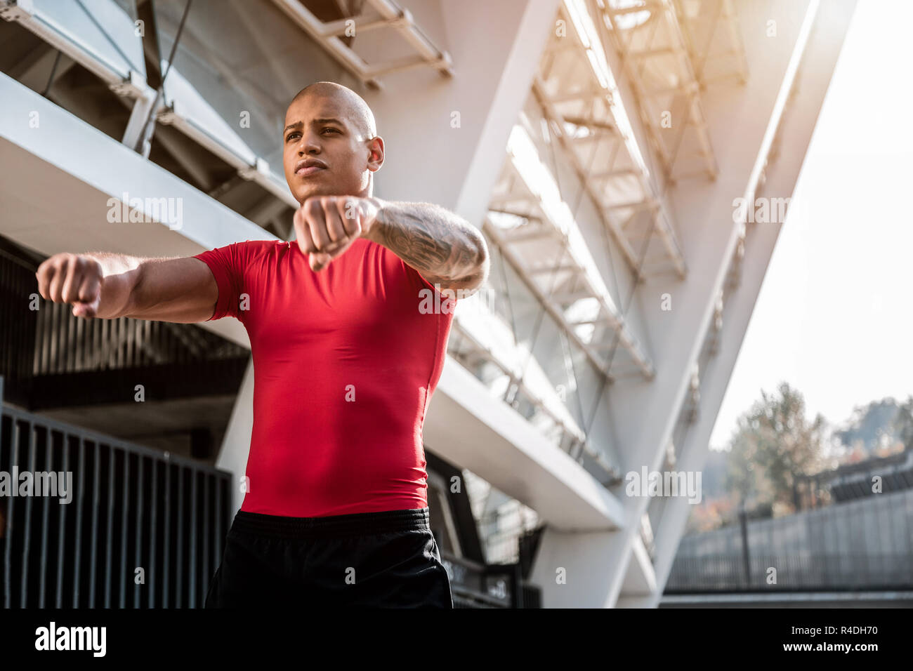 Handsome young man holding his hands in front of him Stock Photo - Alamy
