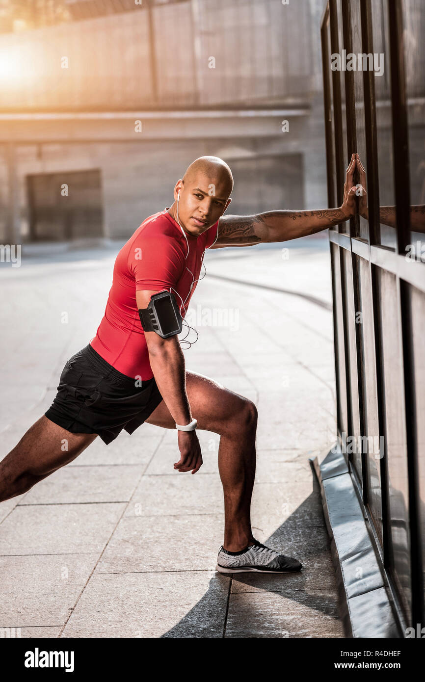 Nice handsome young man stretching his body Stock Photo - Alamy