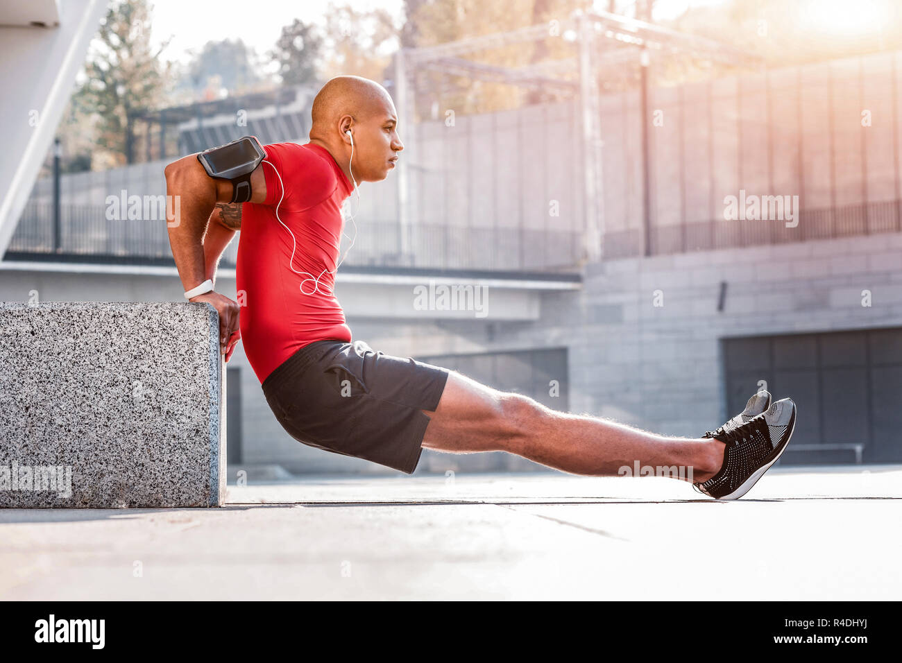 Handsome well built man developing his strength Stock Photo - Alamy