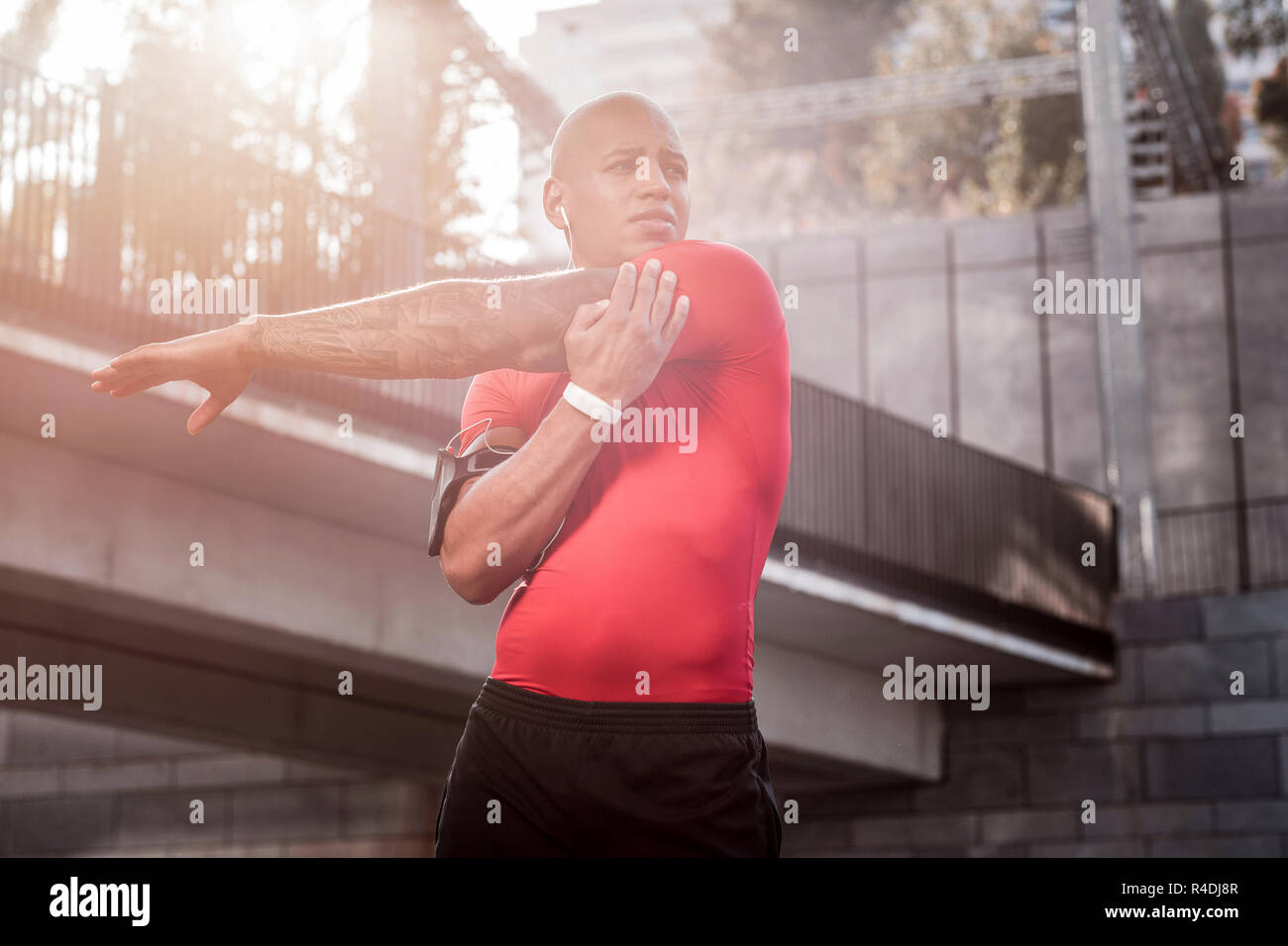 Nice good looking man touching his hand Stock Photo - Alamy