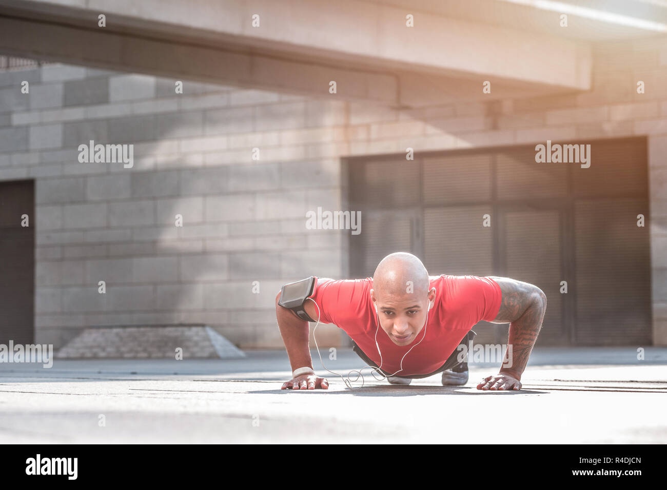 Strong young man doing pushups during the workout Stock Photo - Alamy