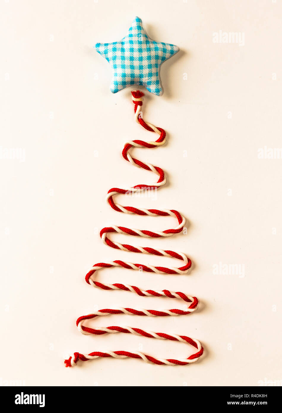 Christmas tree made of cotton thread and a homemade star. Minimalism ...