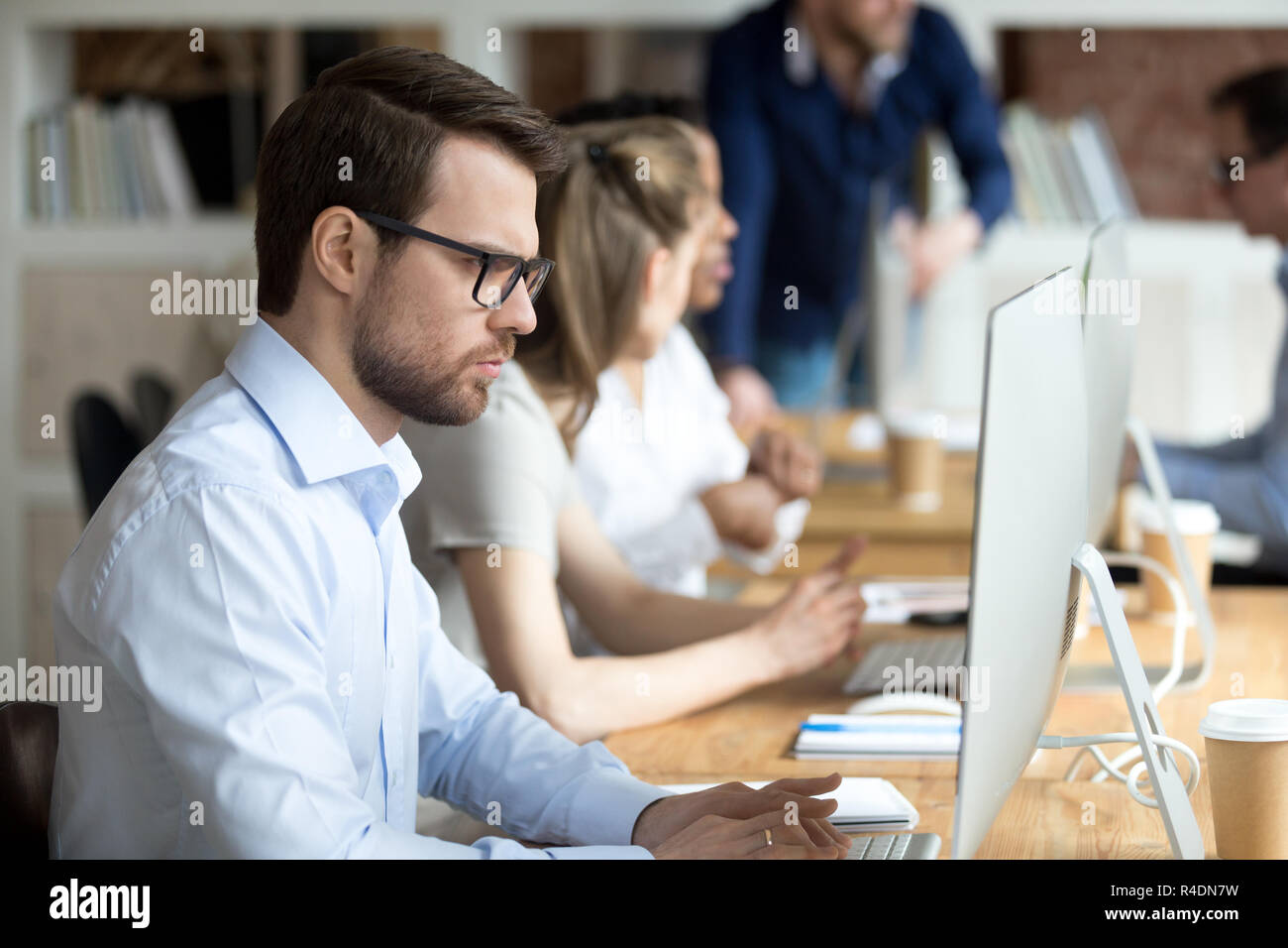 Serious focused businessman looking at monitor screen Stock Photo - Alamy