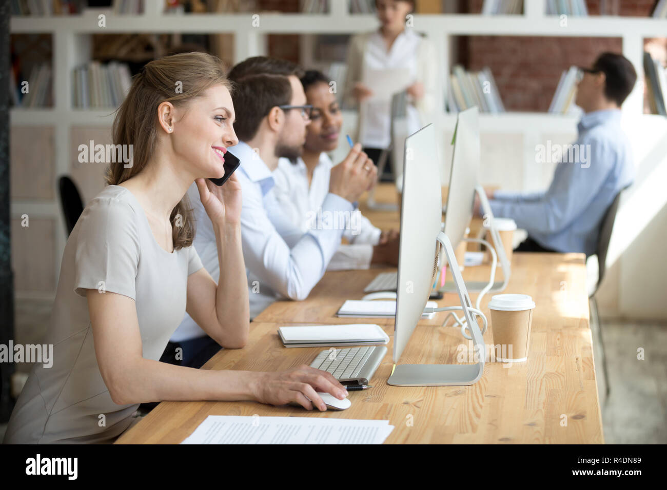 Confident employee talking by phone with client, customer Stock Photo ...