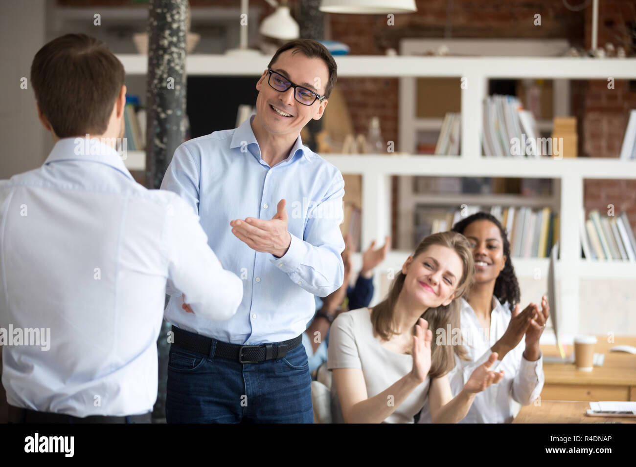 Middle aged boss, mentor congratulating employee, shaking hand Stock ...