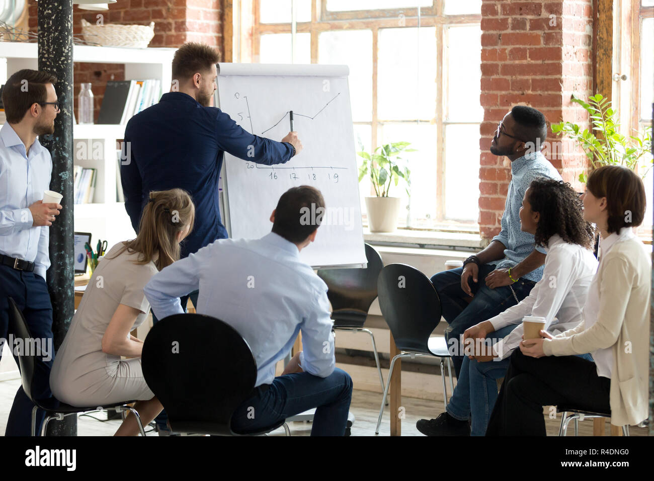 Male business coach speaking presentation to colleagues group Stock ...