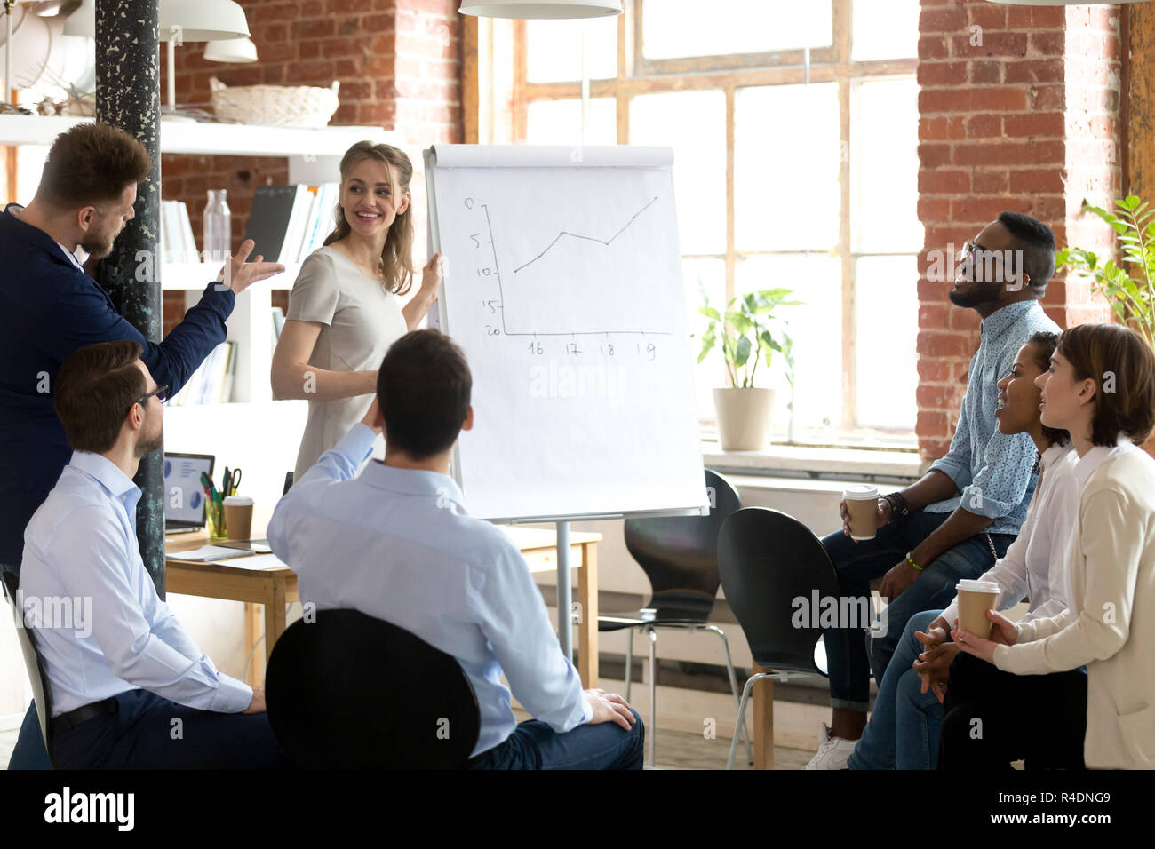 Employee asking questions to female business coach, speaker Stock Photo ...