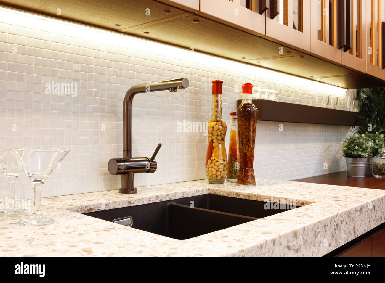Kitchen interior, glass bottles with corn, nuts, oil, jam in a modern ...