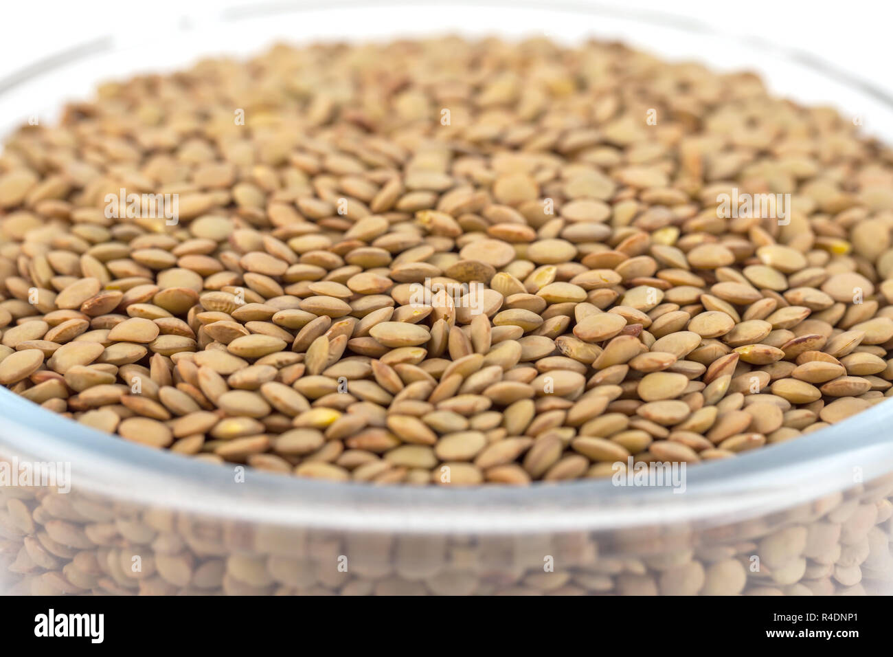 Dry lentil in glass bowl isolated on white background Stock Photo - Alamy
