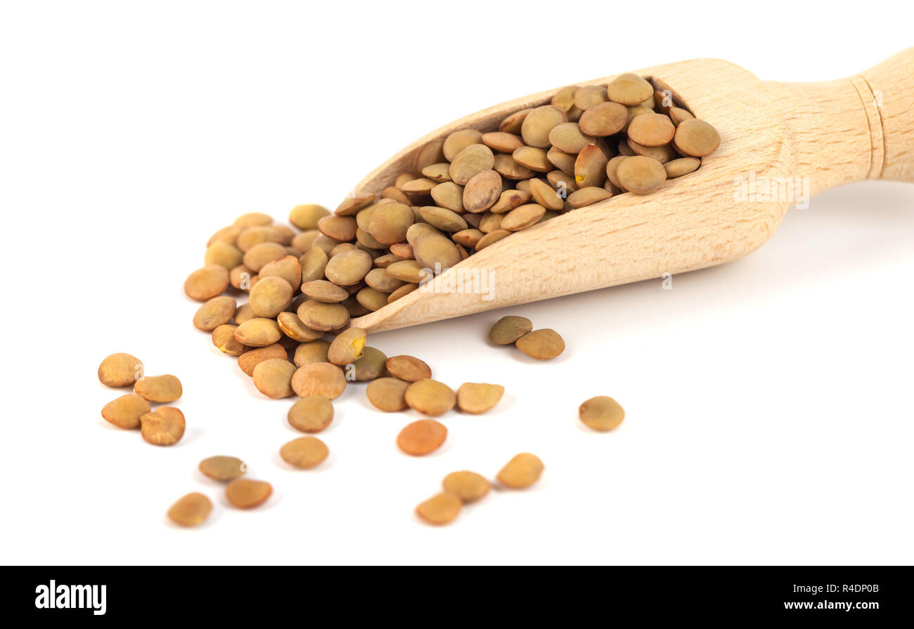 dry lentils on wooden spoon isolated on a white background Stock Photo ...