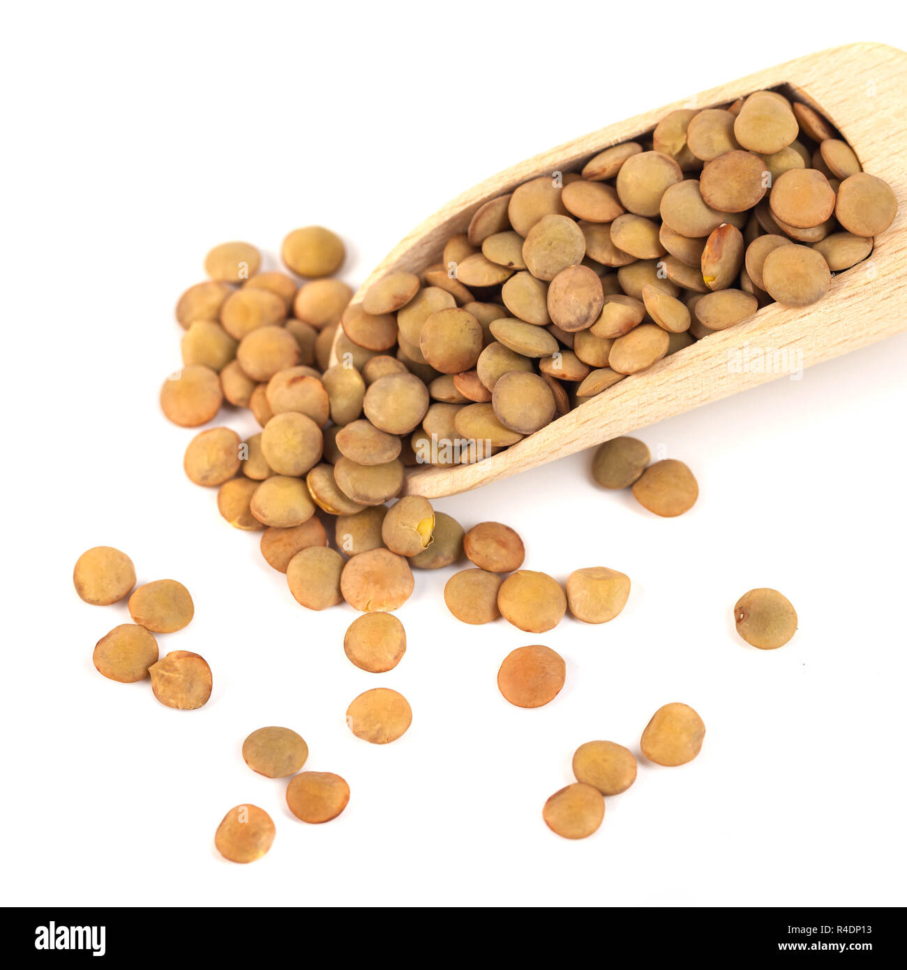 dry lentils on wooden spoon isolated on a white background Stock Photo ...