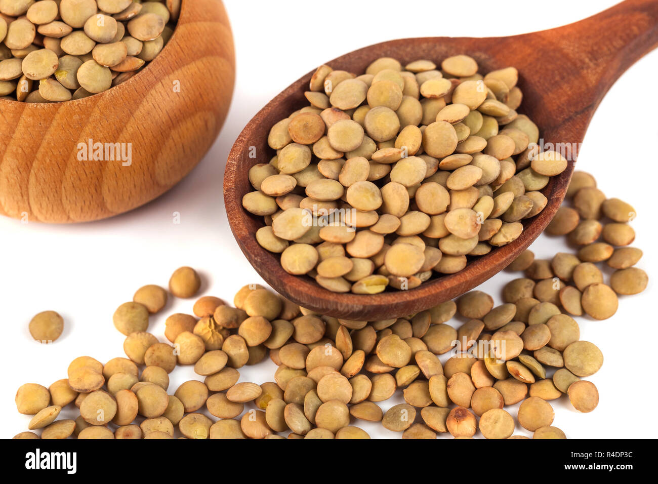 dry lentils on wooden spoon isolated on a white background Stock Photo ...