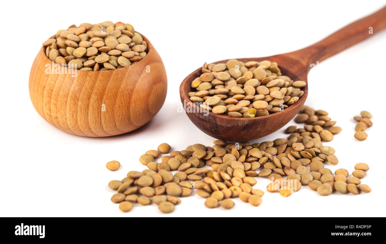 dry lentils on wooden spoon isolated on a white background Stock Photo ...