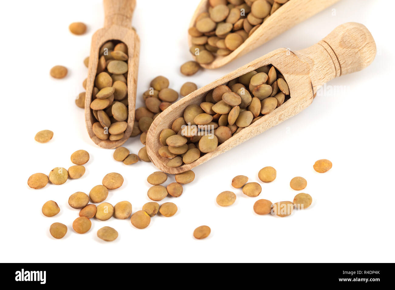 dry lentils on wooden spoon isolated on a white background Stock Photo ...