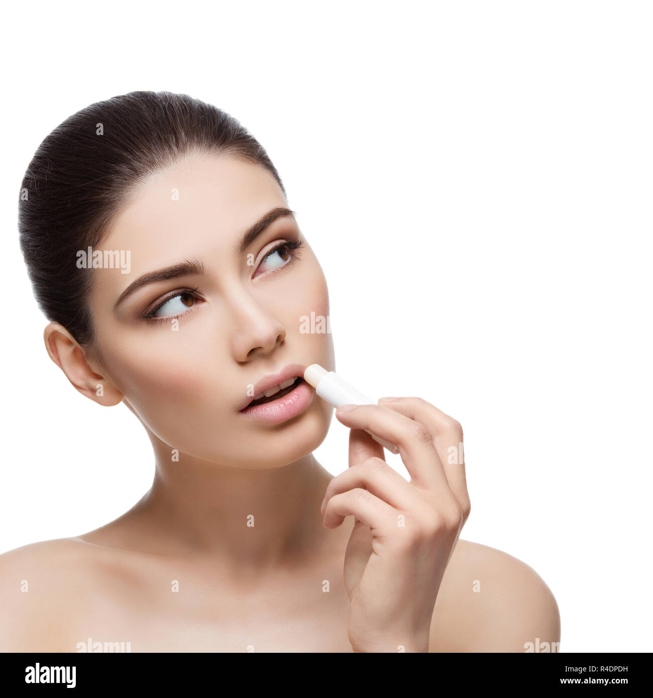Beautiful girl applying chapstick Stock Photo - Alamy