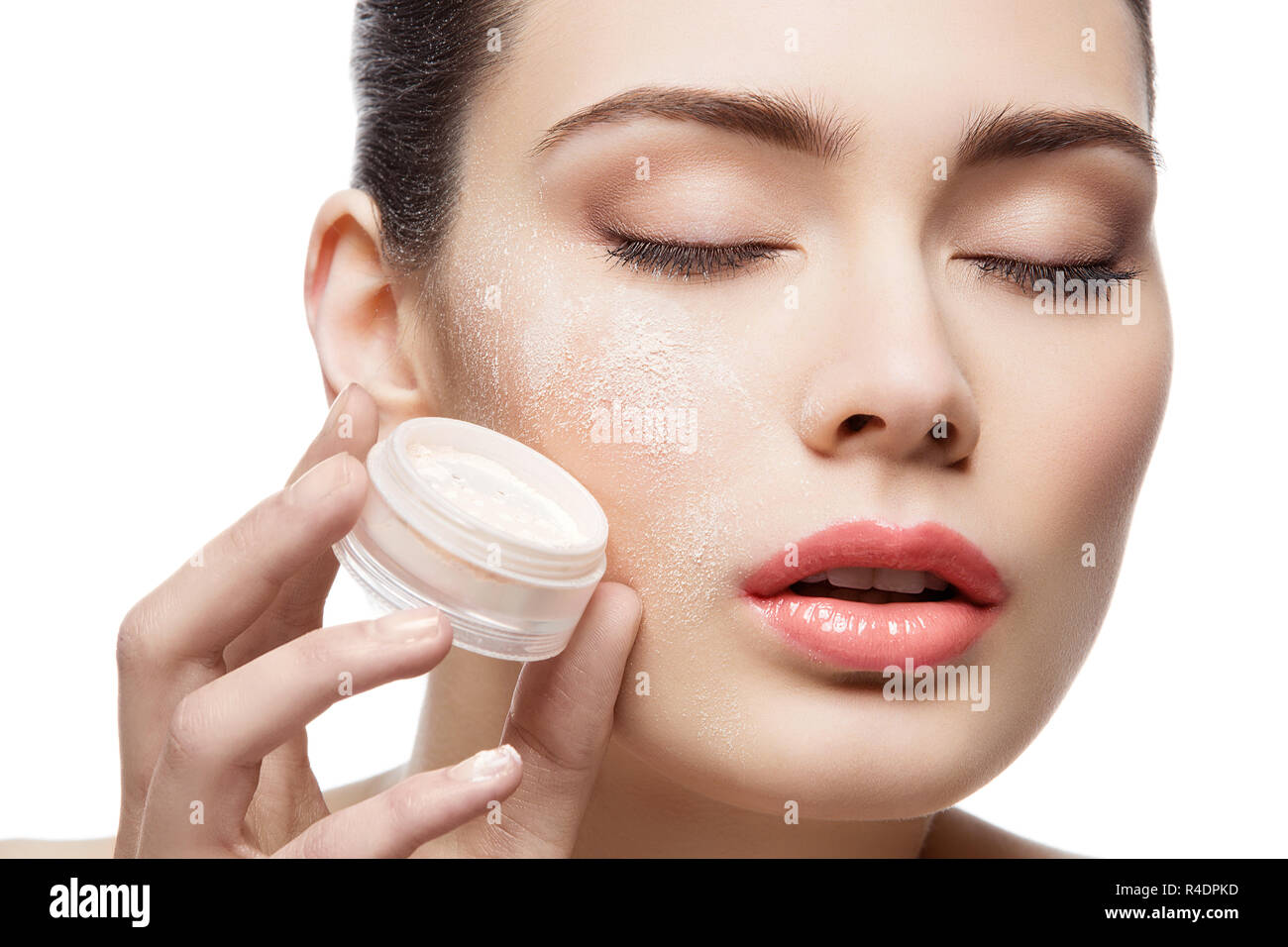 Beautiful girl holding jar with loose powder Stock Photo - Alamy