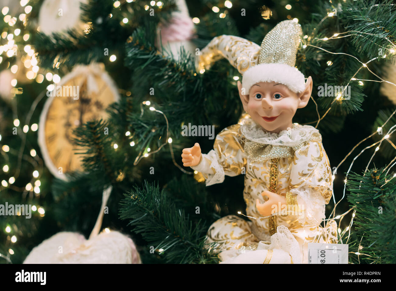 Toy Christmas elf hanging on a Christmas tree Stock Photo - Alamy