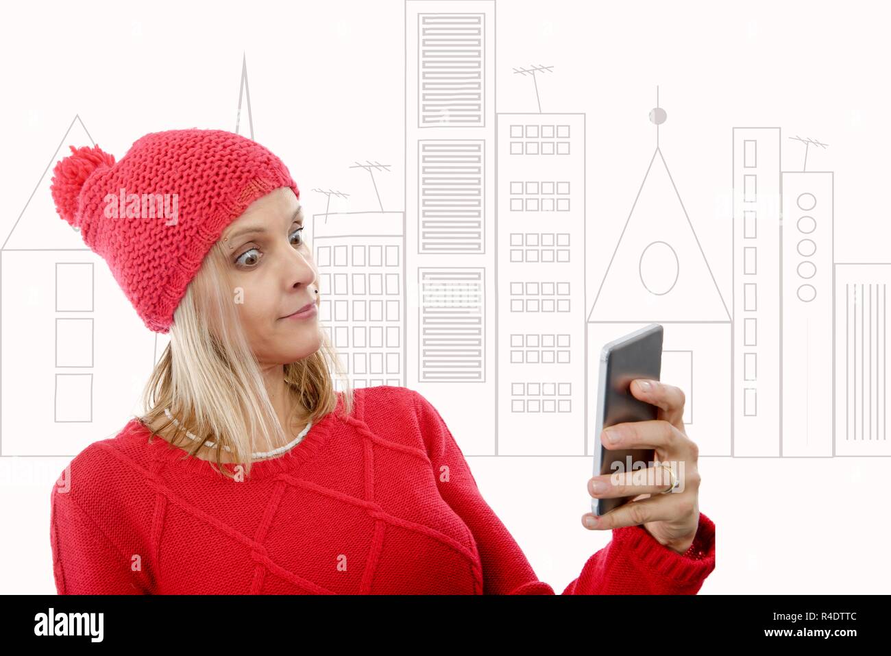 Beautiful young blonde woman with a red cap, phone Stock Photo - Alamy