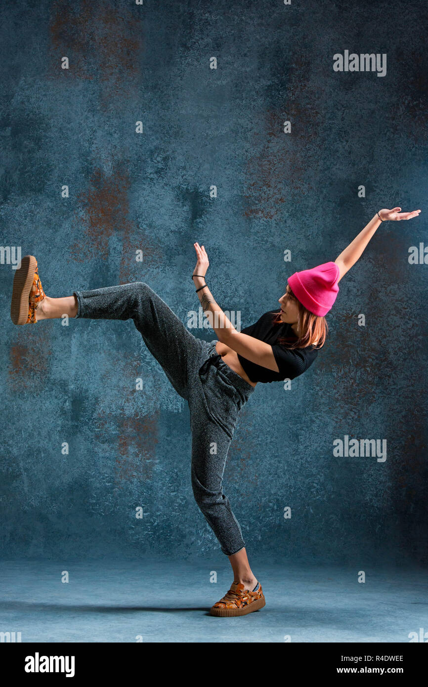 Young girl break dancing on blue studio background Stock Photo - Alamy