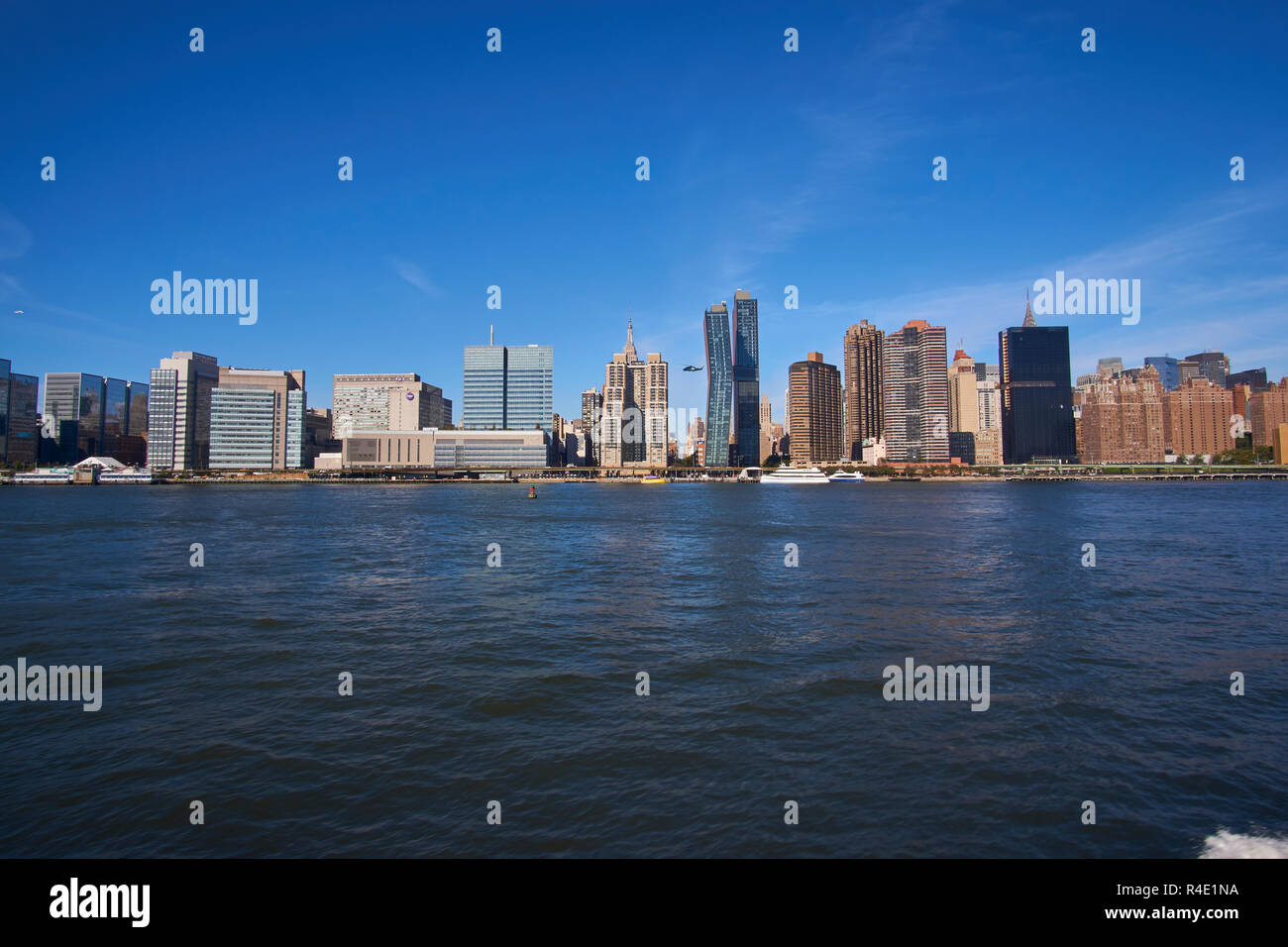 New York City high buildings, a blue sky and water Stock Photo - Alamy
