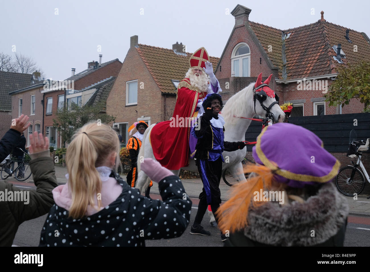 Sinterklaas (St. Nicholas), accompanied by people dressed as ...