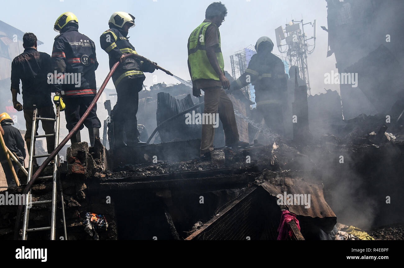 Mumbai, India. 27th Nov, 2018. Indian firemen douse a fire that broke ...
