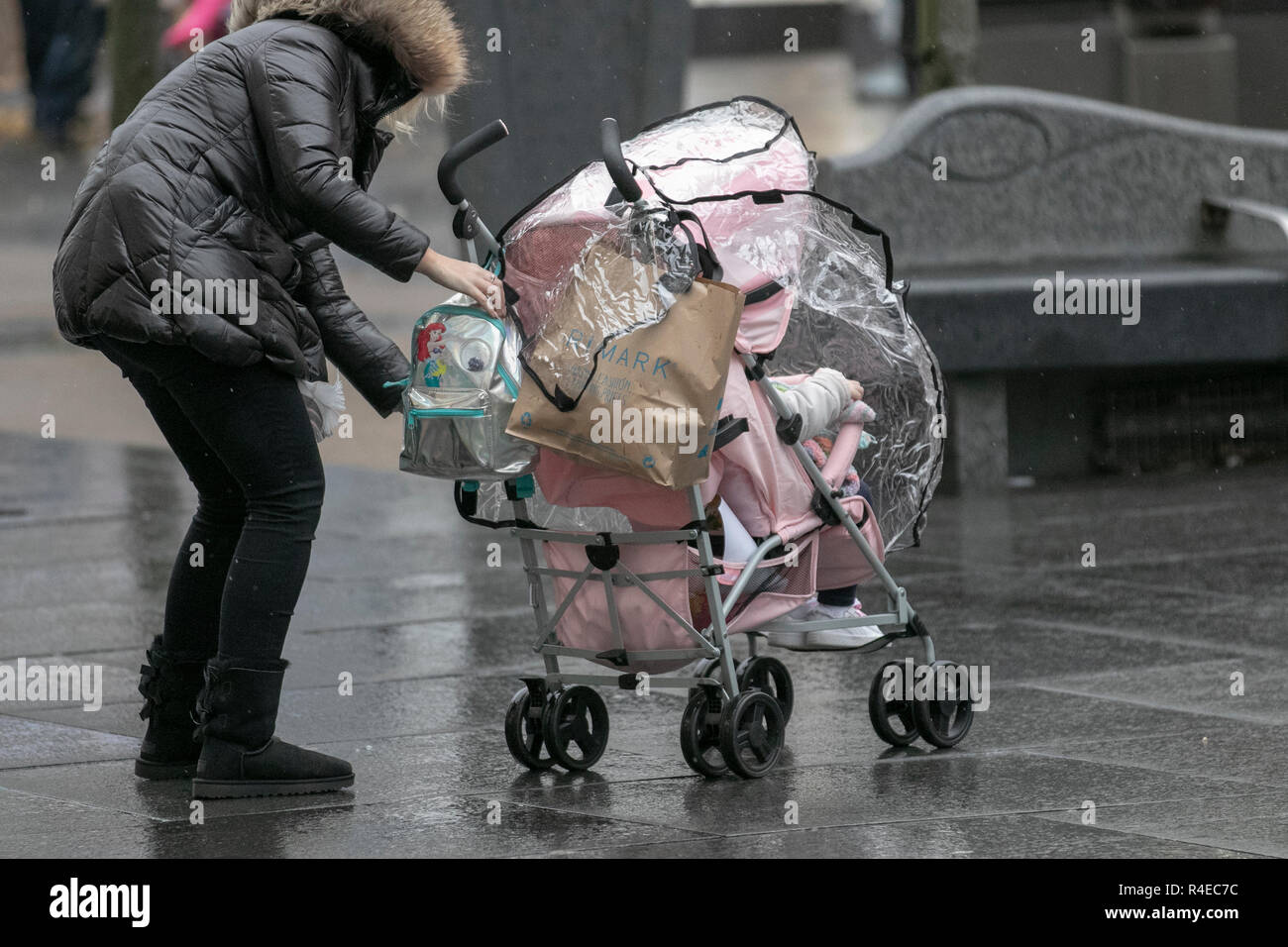 Moter and child in a buggy in Southport, Lancashire, UK Weather. Nov ...