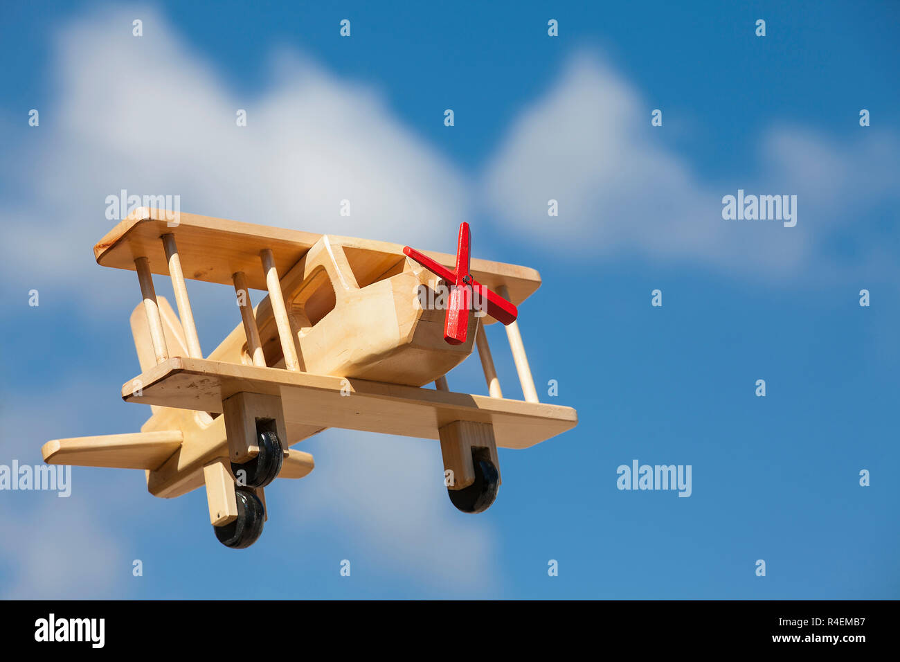 Wooden Plane flying with blue sky and white clouds - Going up Stock ...