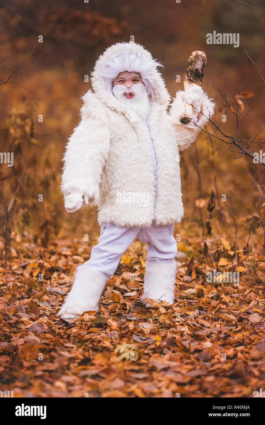 Boy standing in the forest dressed as a yeti for Halloween, United ...