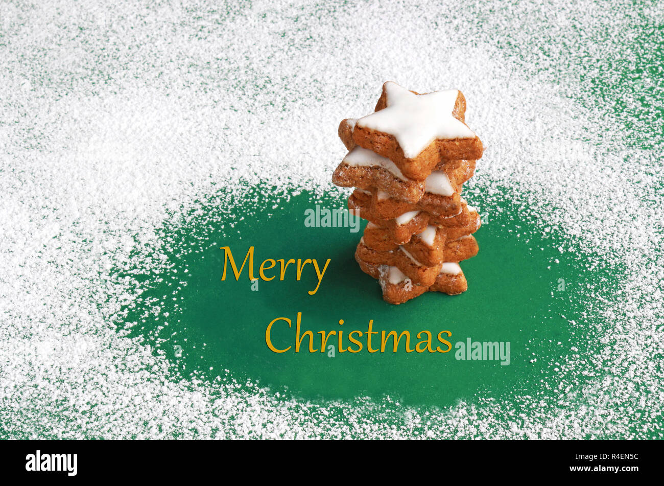 Merry Christmas, green greeting card with a pile of cinnamon star ...