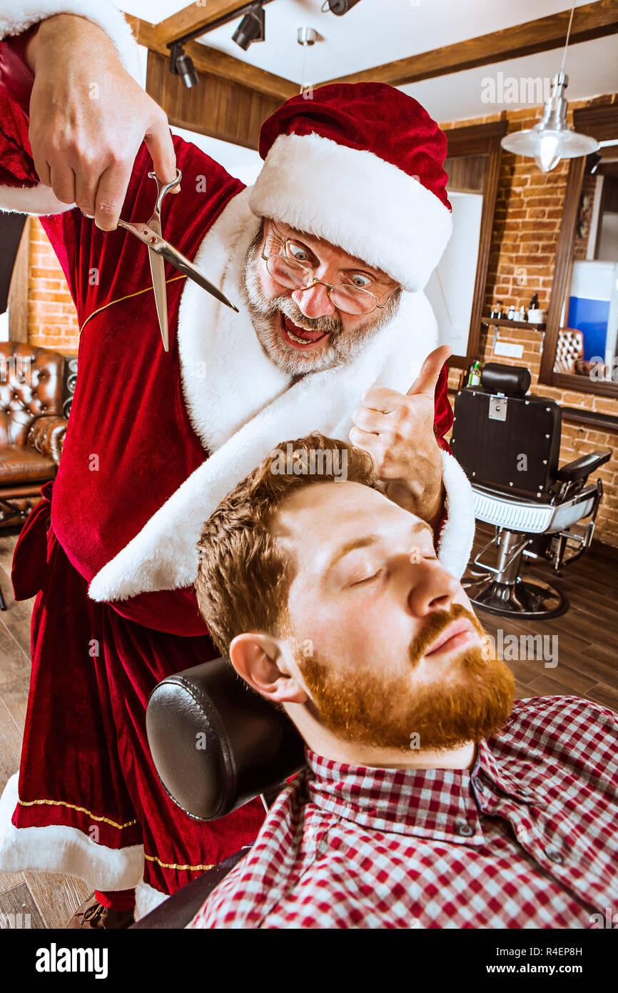Santa claus as master at barber shop Stock Photo - Alamy