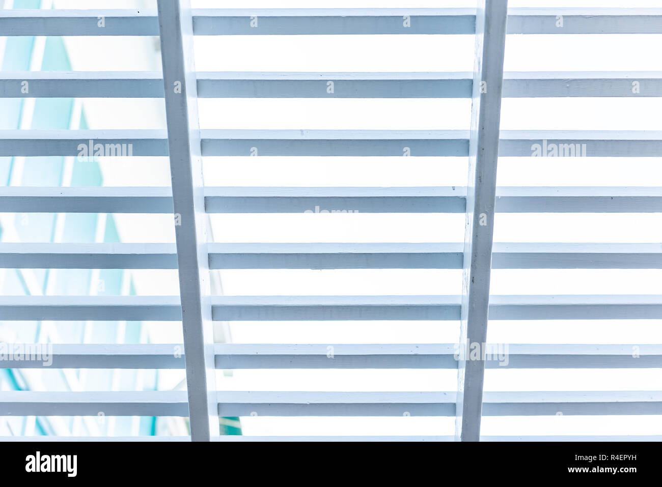 Pastel blue turquoise abstract ceiling roof beams architecture closeup ...