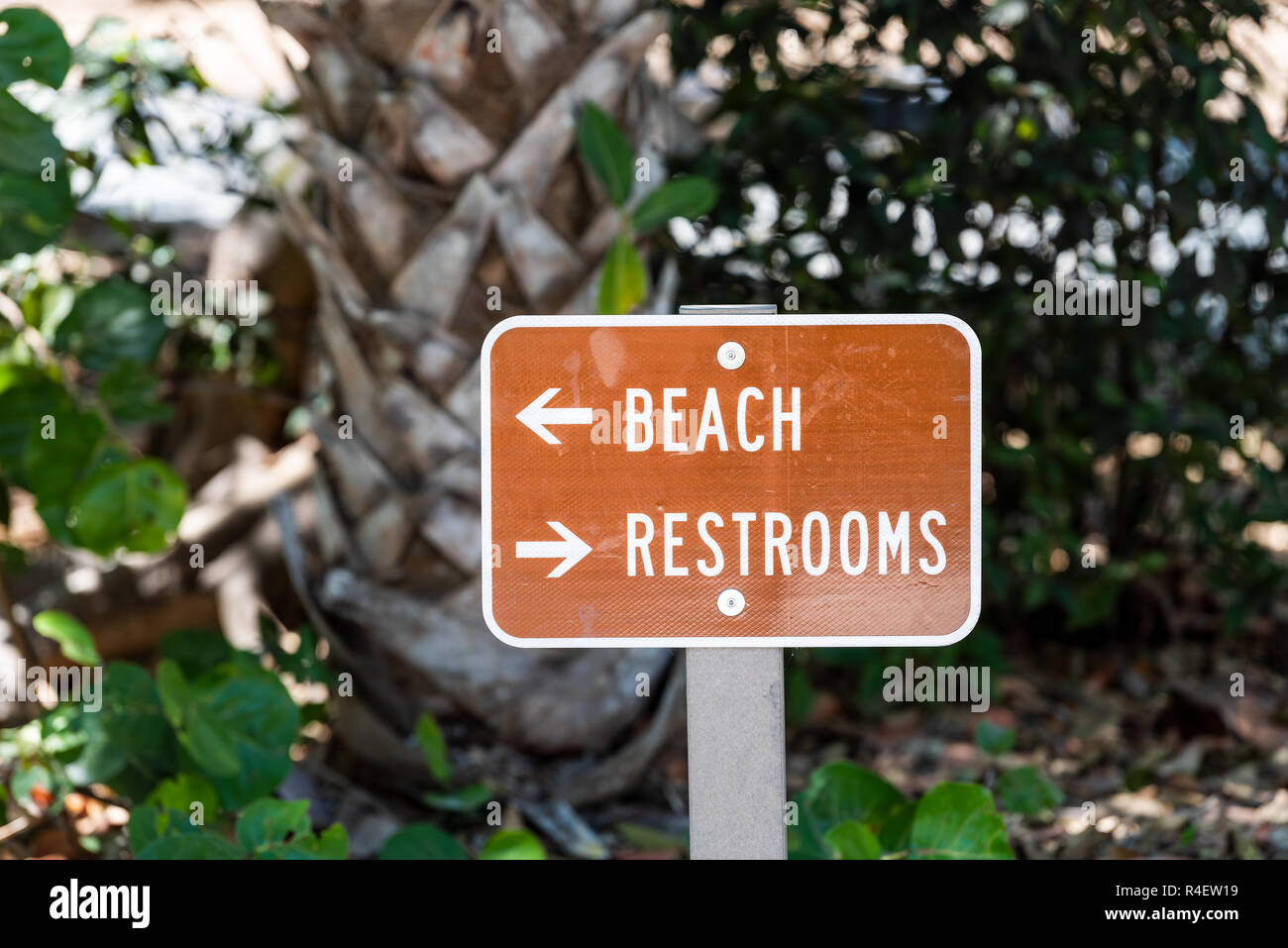 Beach Restrooms bathroom sign on street road in brown color in park on ...
