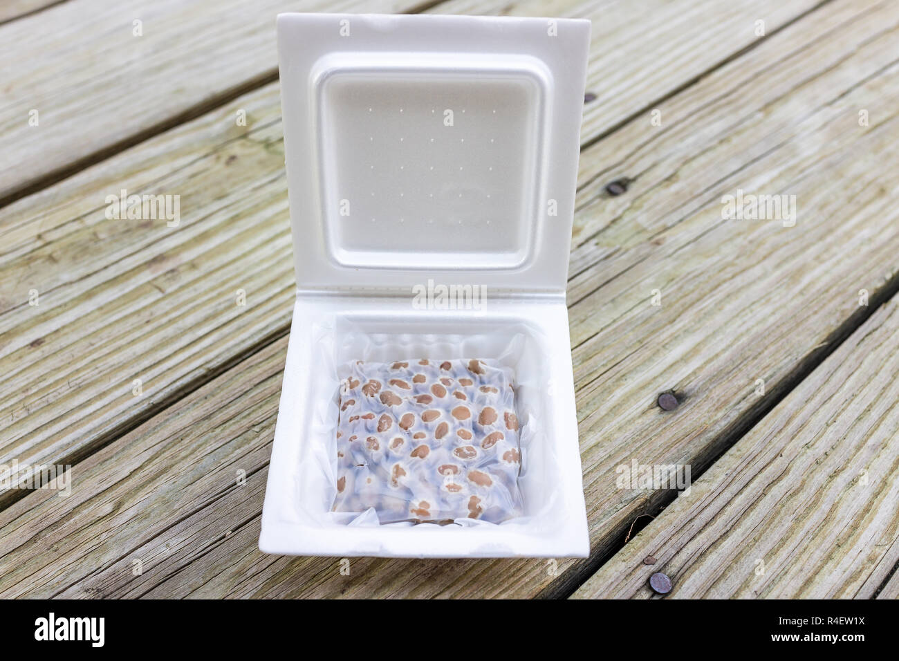 Closeup of Asian Japanese natto fermented soy dish meal, paper film ...