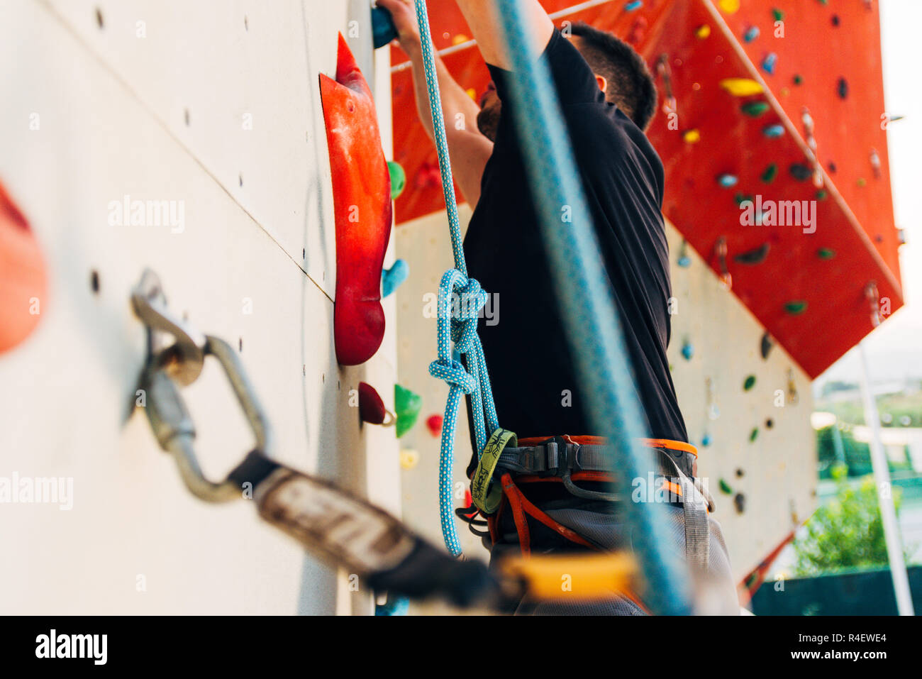 Young man climbing wall rock an extreme sport Stock Photo - Alamy