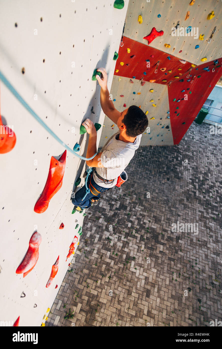Handsome young man bouldering or rock climbing outdoors Stock Photo - Alamy