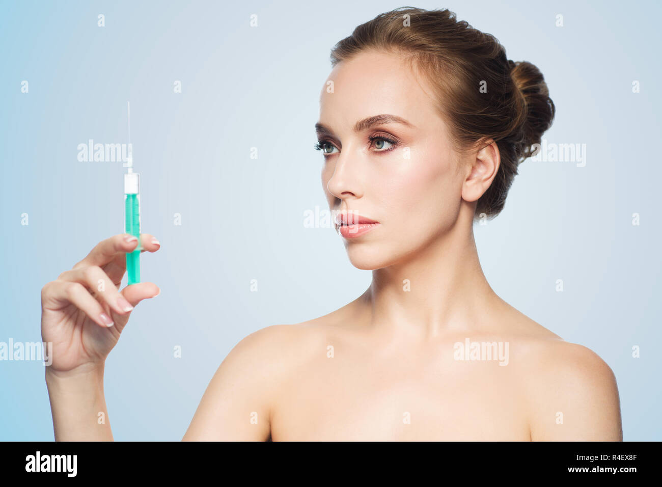 beautiful woman holding syringe with injection Stock Photo - Alamy
