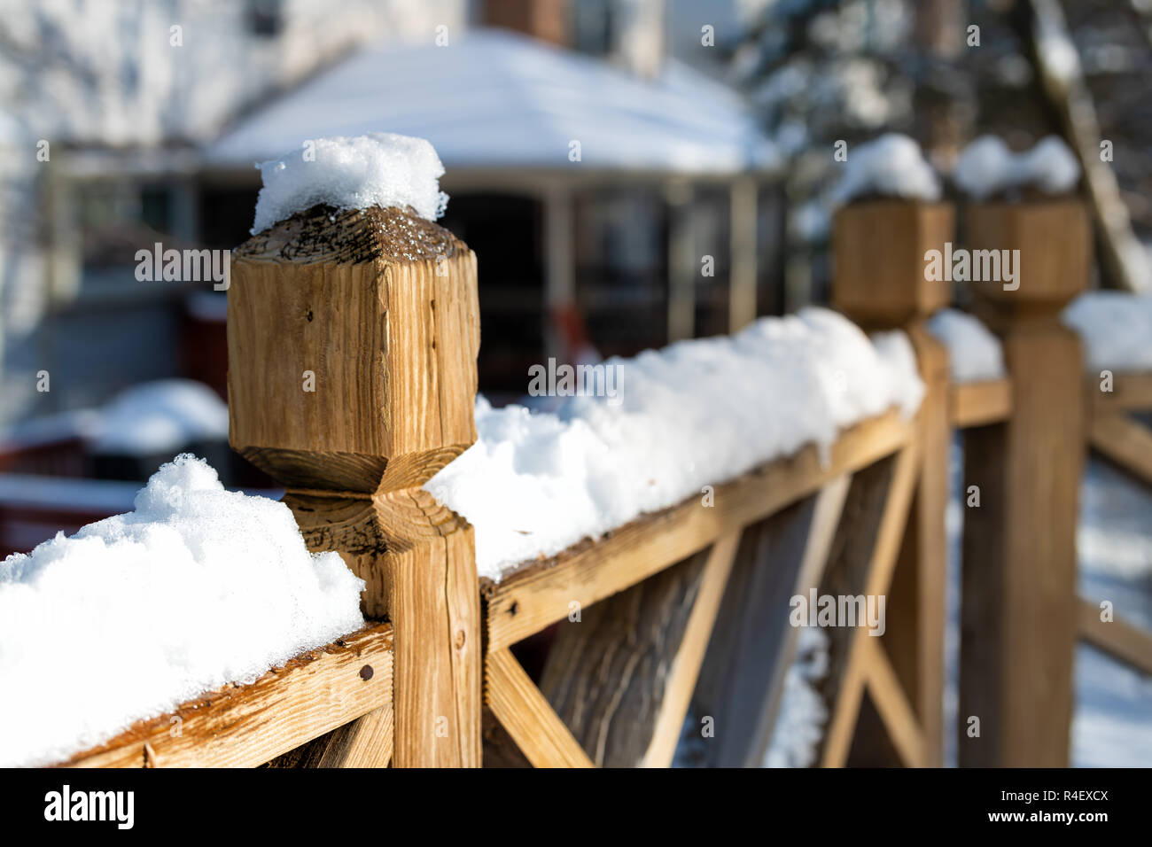 Closeup of wooden deck fence railing side, pole, post covered, in piled ...