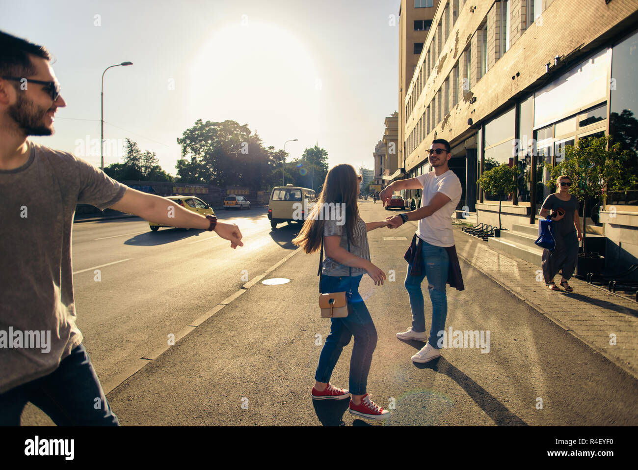 A group of friends walking on the sidewalk in an urban place Stock ...