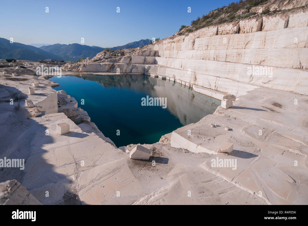 Marble quarry landscape in the mountains with a turquoise lake water ...