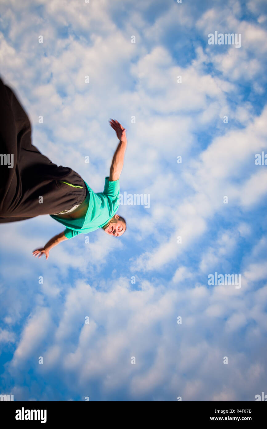 Man trains parkour while jumping in the air Stock Photo - Alamy
