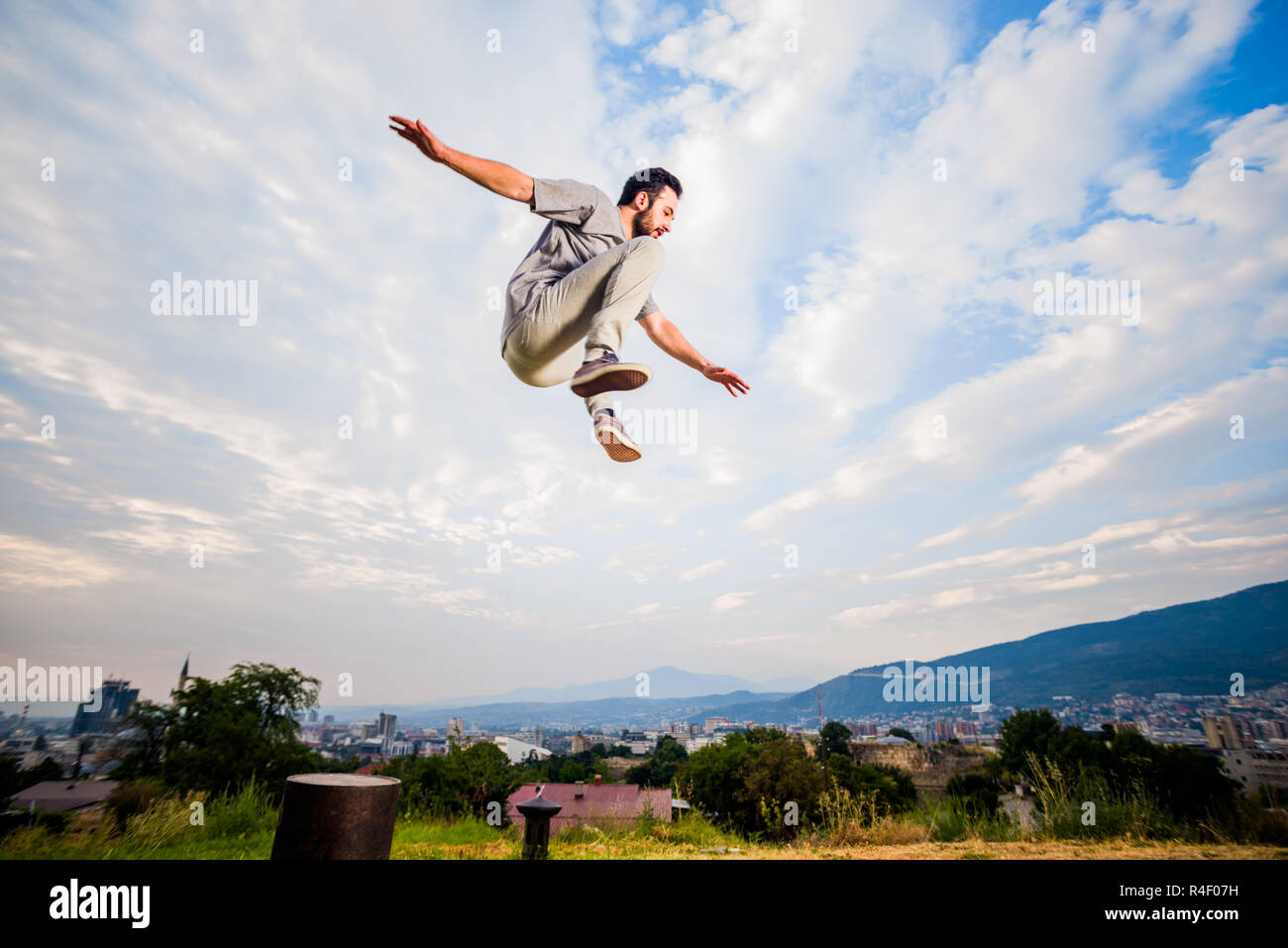Free runner make parkour in the air while jumping outdoor Stock Photo ...